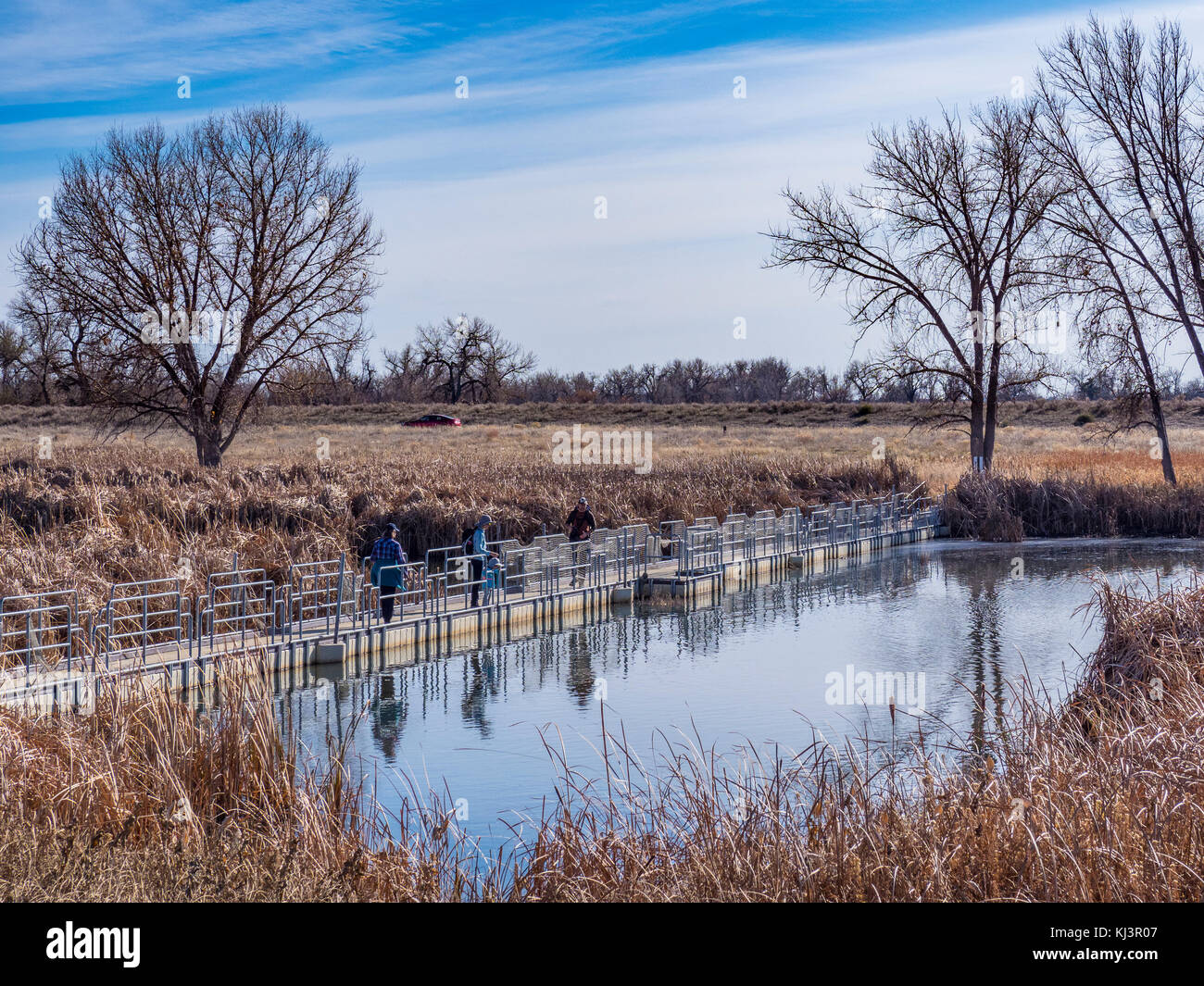 Visitors cross a bridge on the Lake Ladora Loop Trail, autumn, Rocky ...