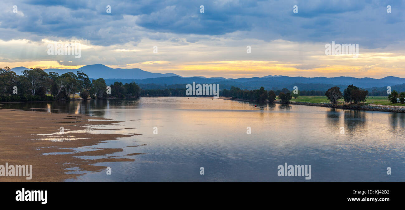 Landscape with shallow lake water and mountains at dusk with beautiful ...