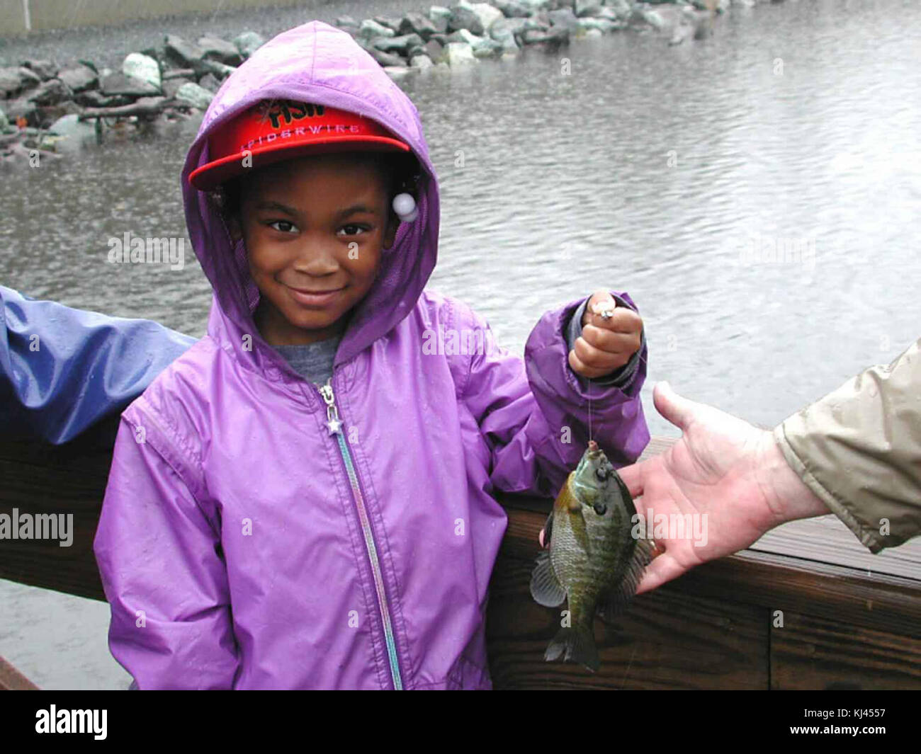 Young African American girl smile holding fishing catch Stock Photo - Alamy