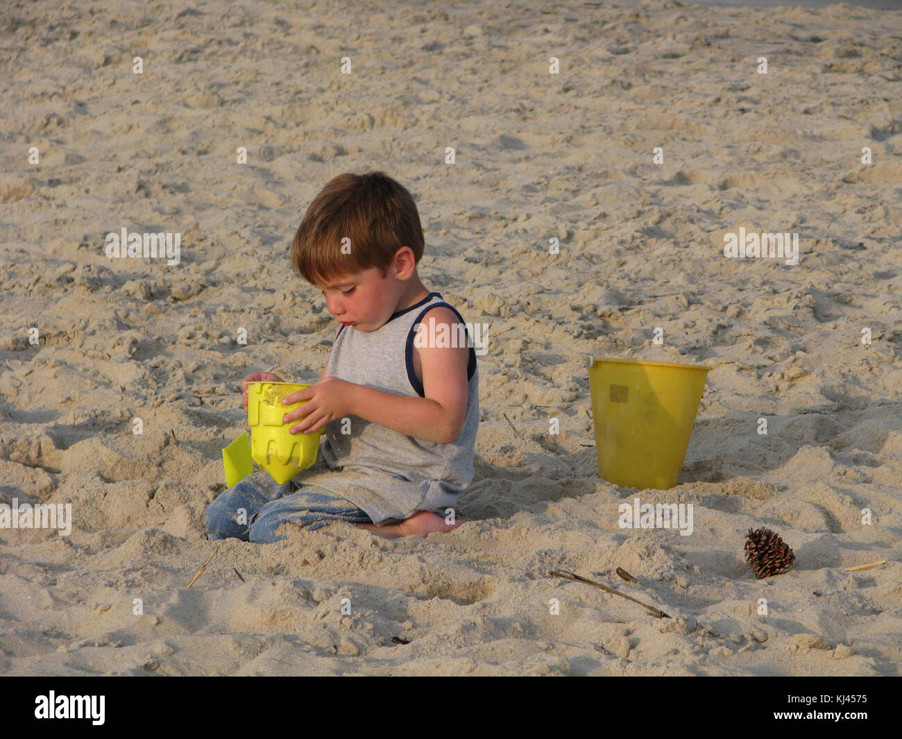 Young boy building a sand castle at the beach Stock Photo - Alamy