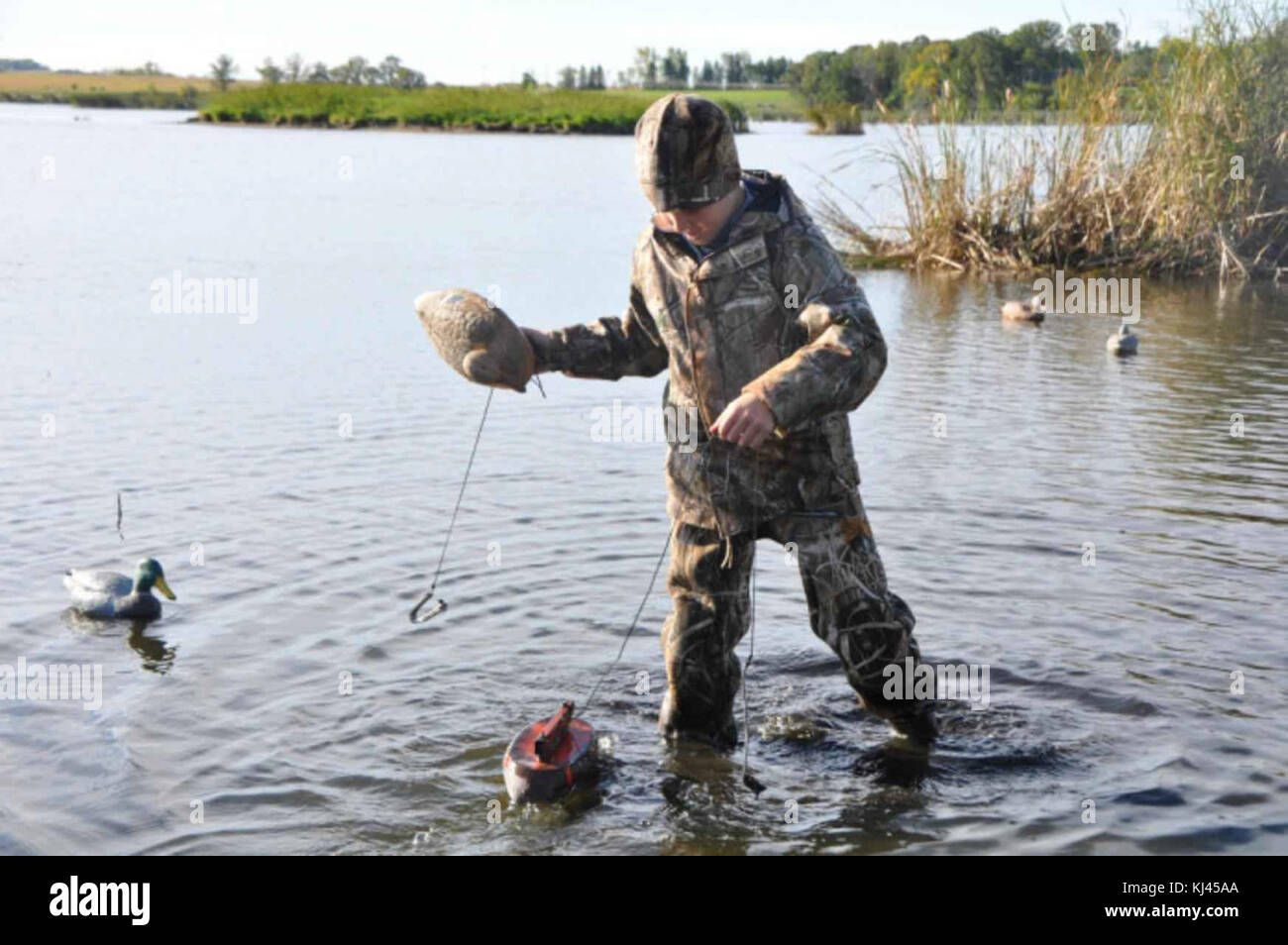 Young boy hunter with duck hunting gear Stock Photo - Alamy