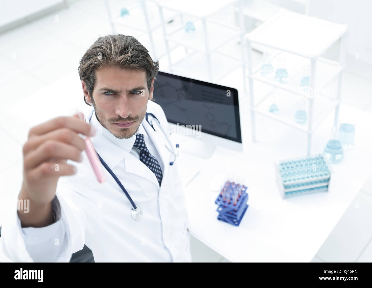 Man in laboratory checking test tubes Stock Photo - Alamy