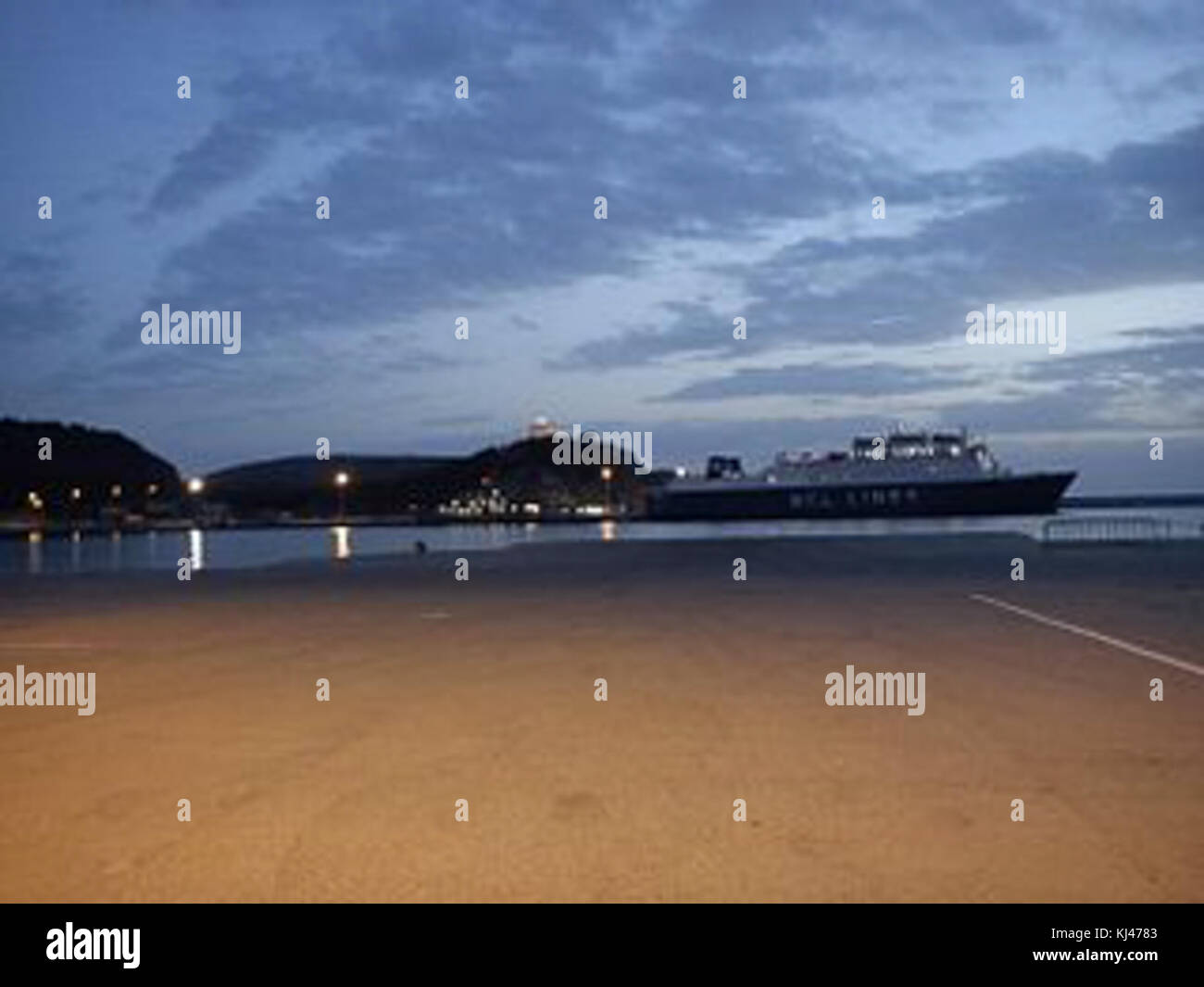 This image depicts a ship docked at a port, showcasing the maritime ...