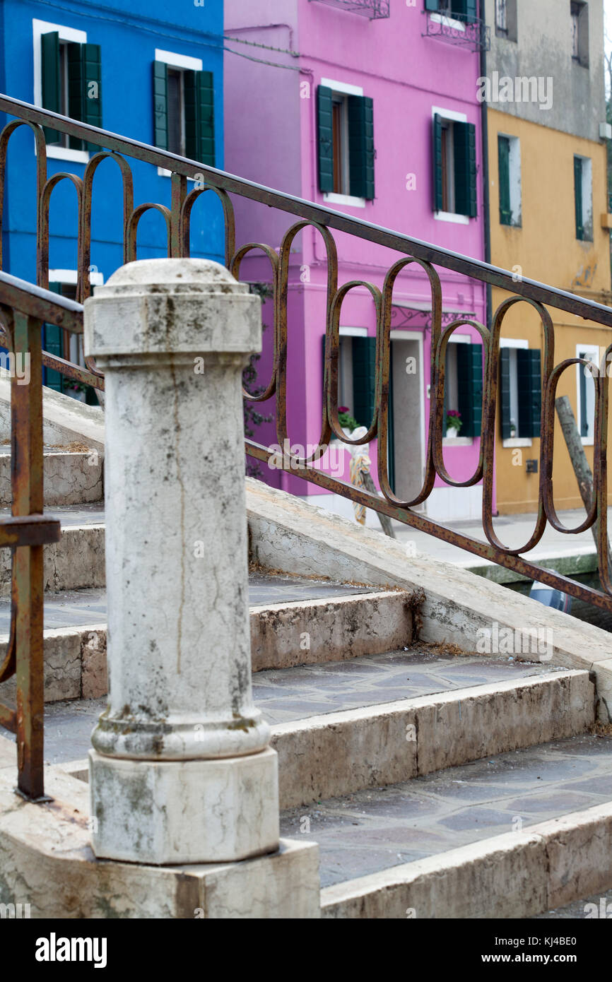 Brightly colored blue, pink and orange, houses with Bridge with metal ...