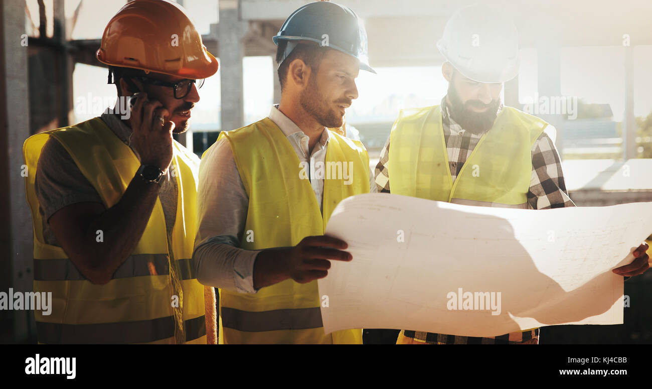 Portrait of construction engineers working on building site Stock Photo ...