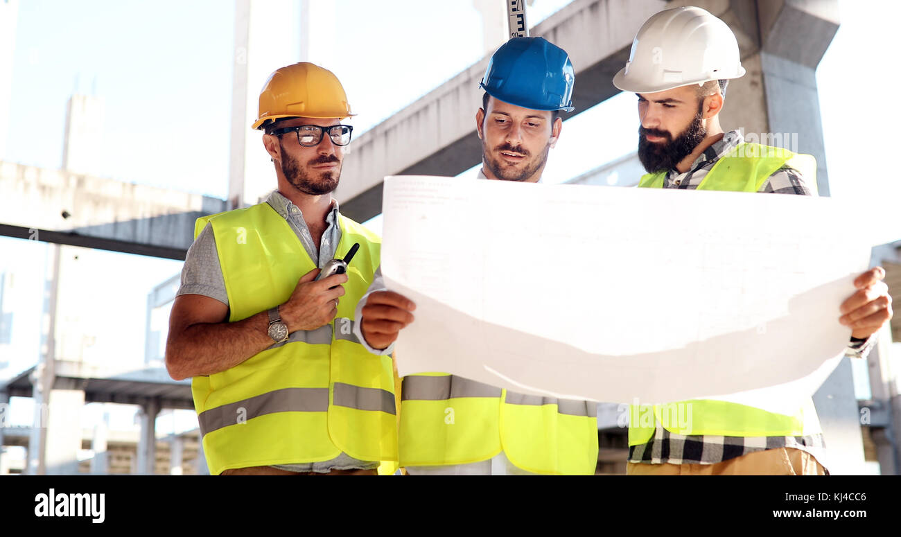 Portrait of construction engineers working on building site Stock Photo ...