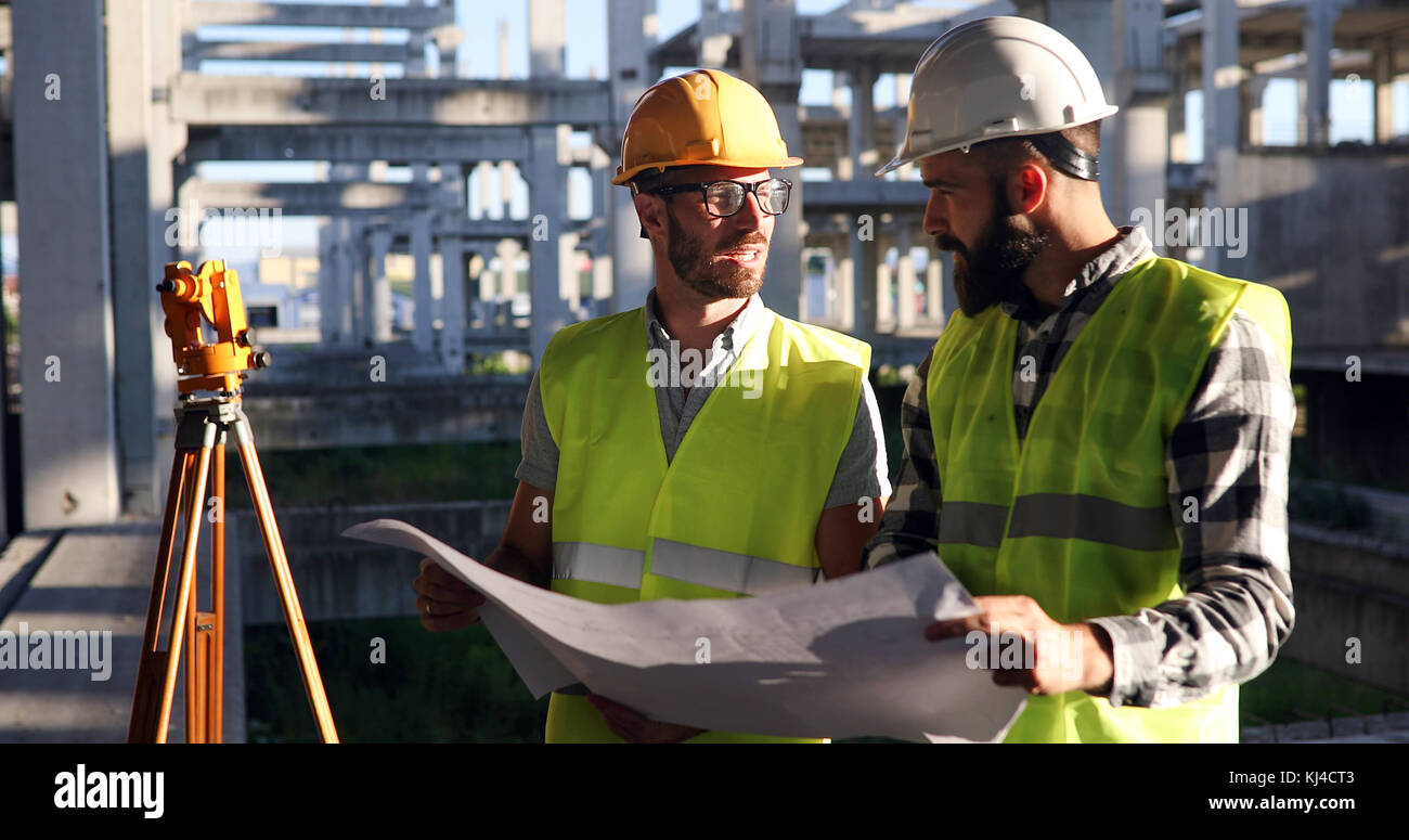 Portrait of construction engineers working on building site Stock Photo ...