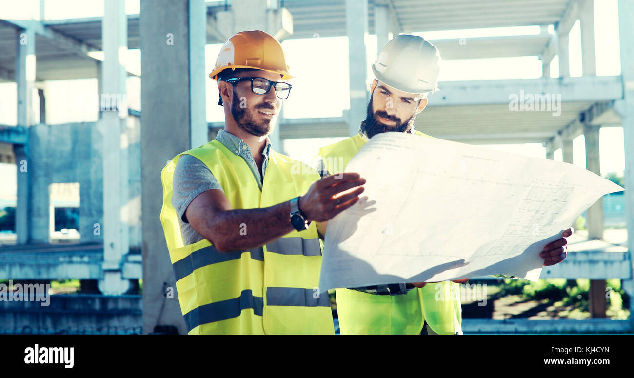 Team of architects people in group on construciton site Stock Photo - Alamy