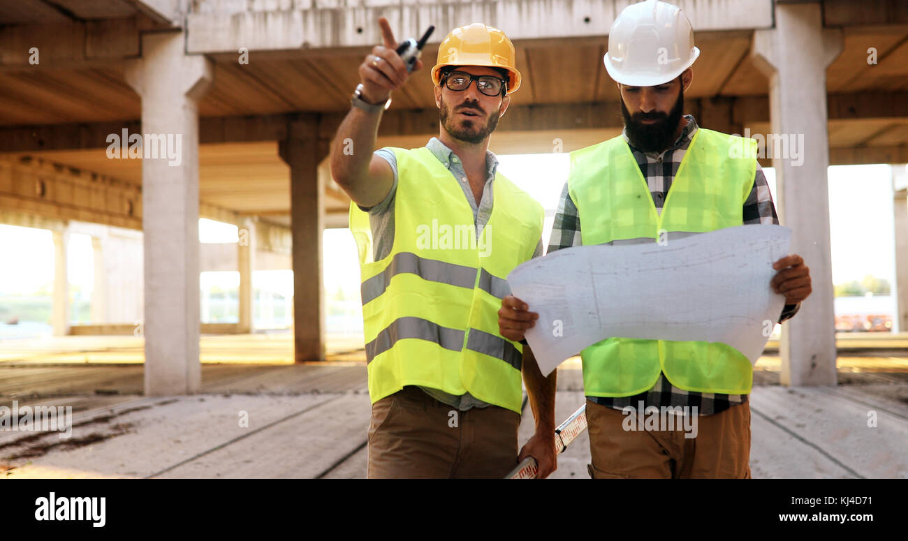Team of architects people in group on construciton site Stock Photo - Alamy