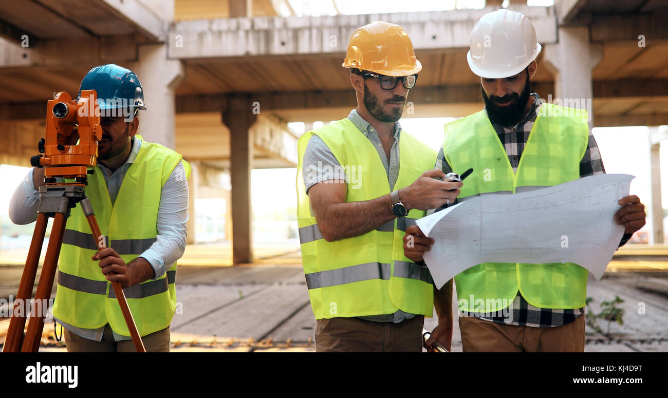 Team of architects people in group on construciton site Stock Photo - Alamy
