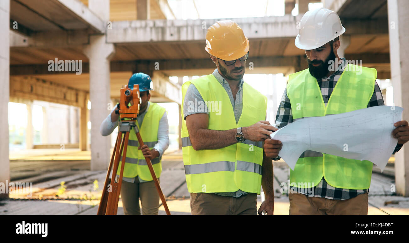 Portrait of construction engineers working on building site Stock Photo ...