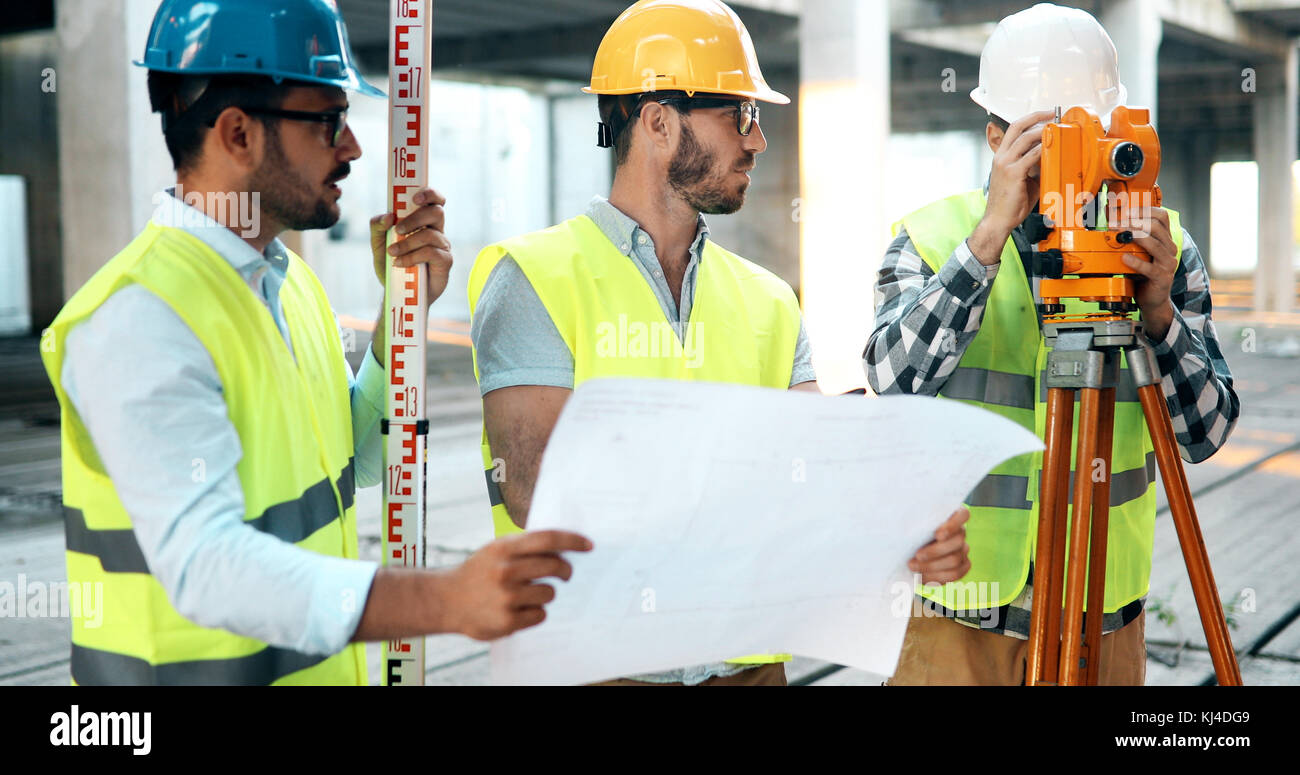 Team of architects people in group on construciton site Stock Photo - Alamy