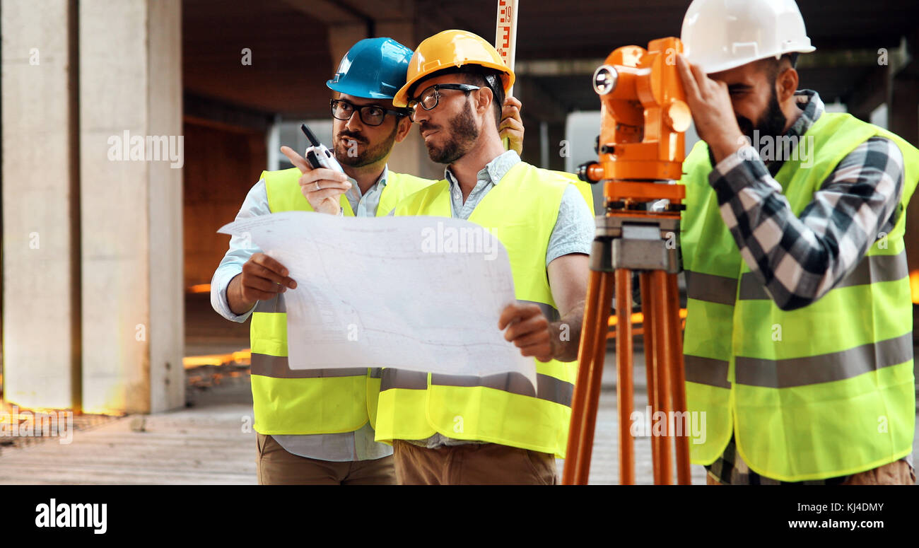 Team of architects people in group on construciton site Stock Photo - Alamy