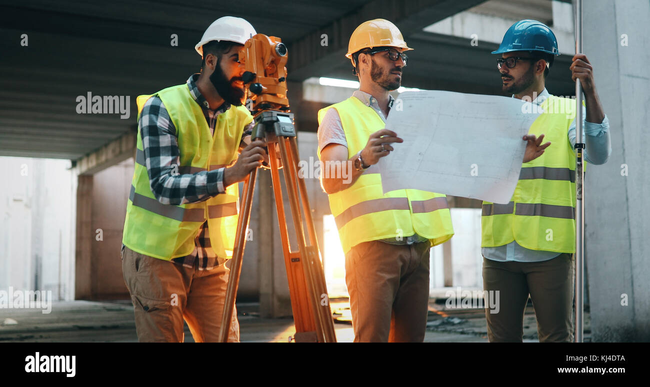 Team of architects people in group on construciton site Stock Photo - Alamy