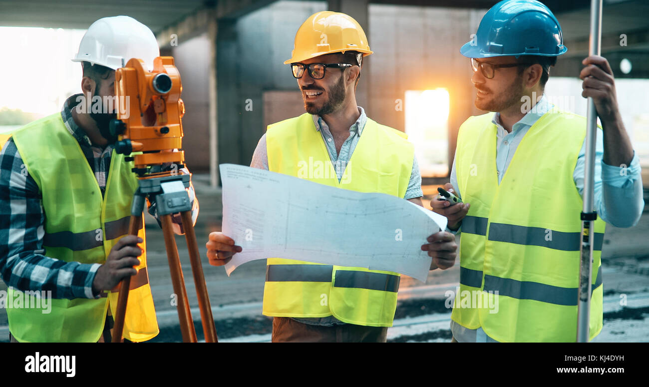 Construction engineers discussion with architects at construction site ...