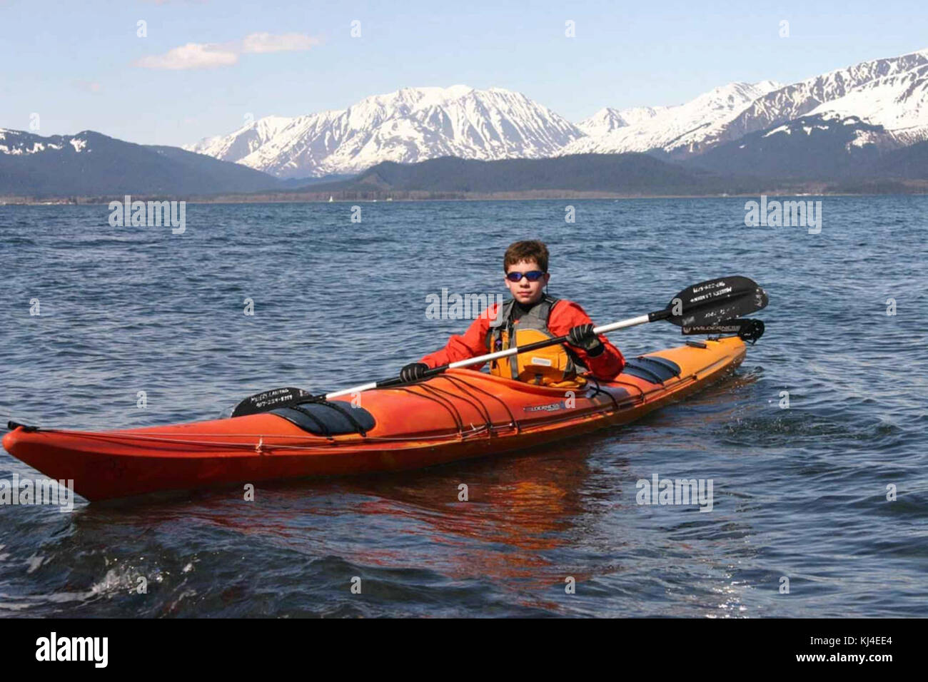 Boy paddling in a kayak Stock Photo - Alamy
