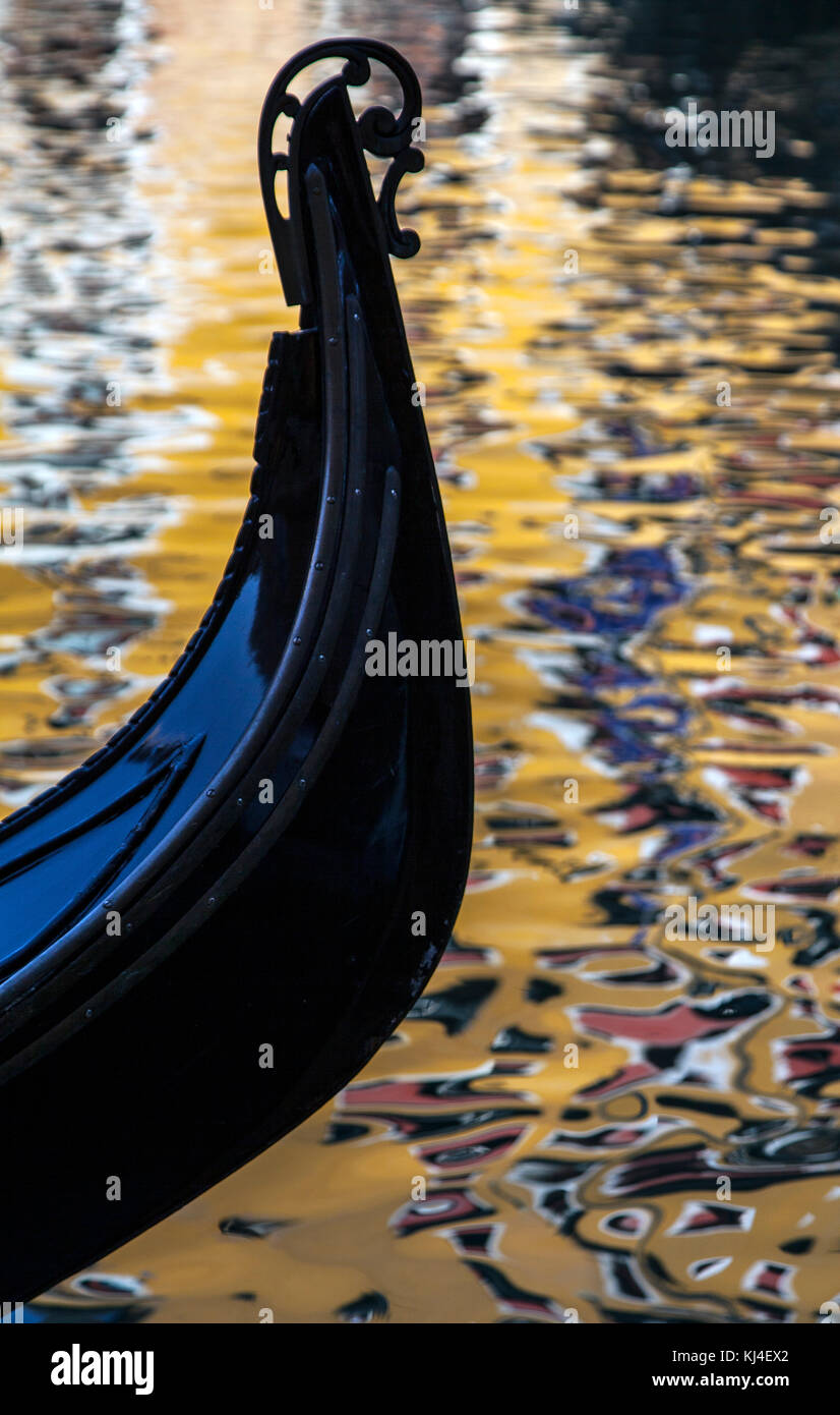 Gondola with colourful abstract reflection of buildings in the canal in ...