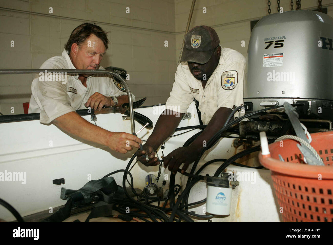 Busy people maintaining boat Stock Photo - Alamy