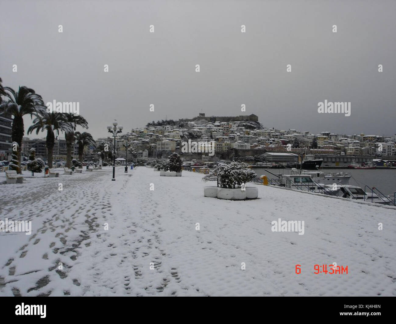 This photograph of Kavala harbour in snow captures the serene beauty of ...