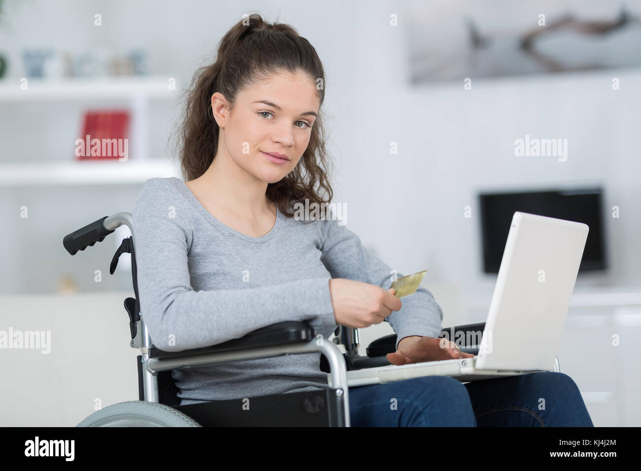 Young disabled girl using laptop Stock Photo - Alamy