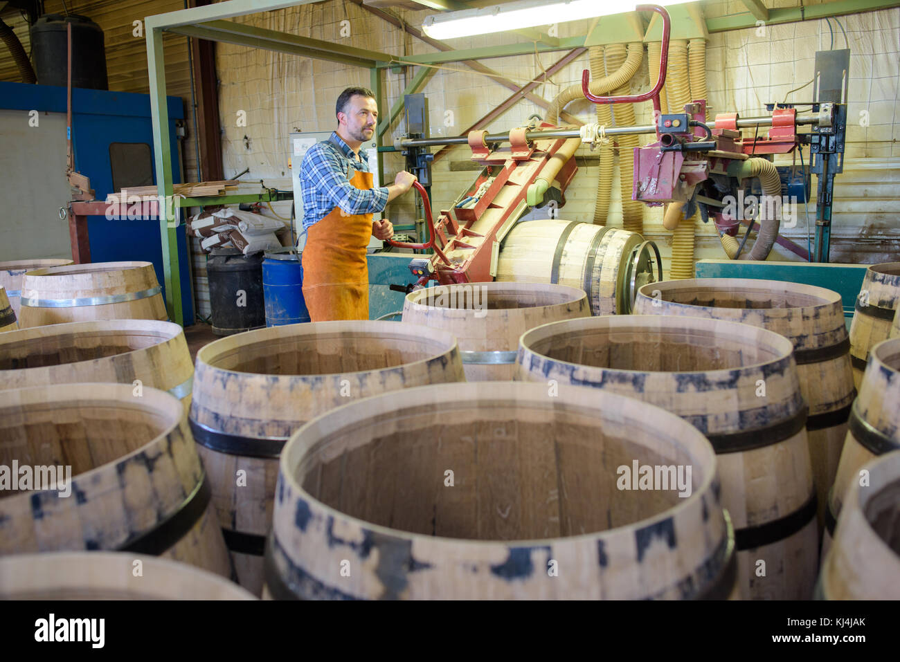 Cooper in background of barrel making factory Stock Photo - Alamy