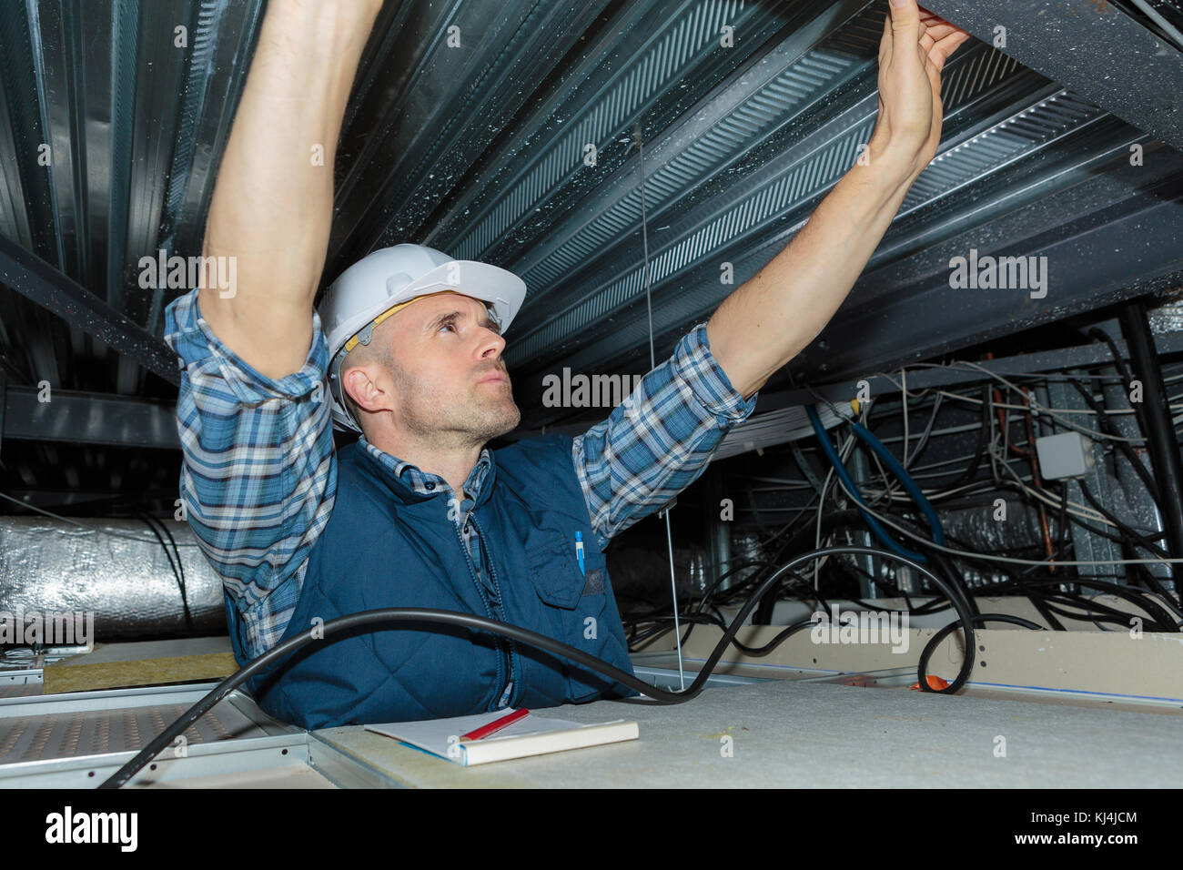 worker fixing ceiling panel in building Stock Photo - Alamy