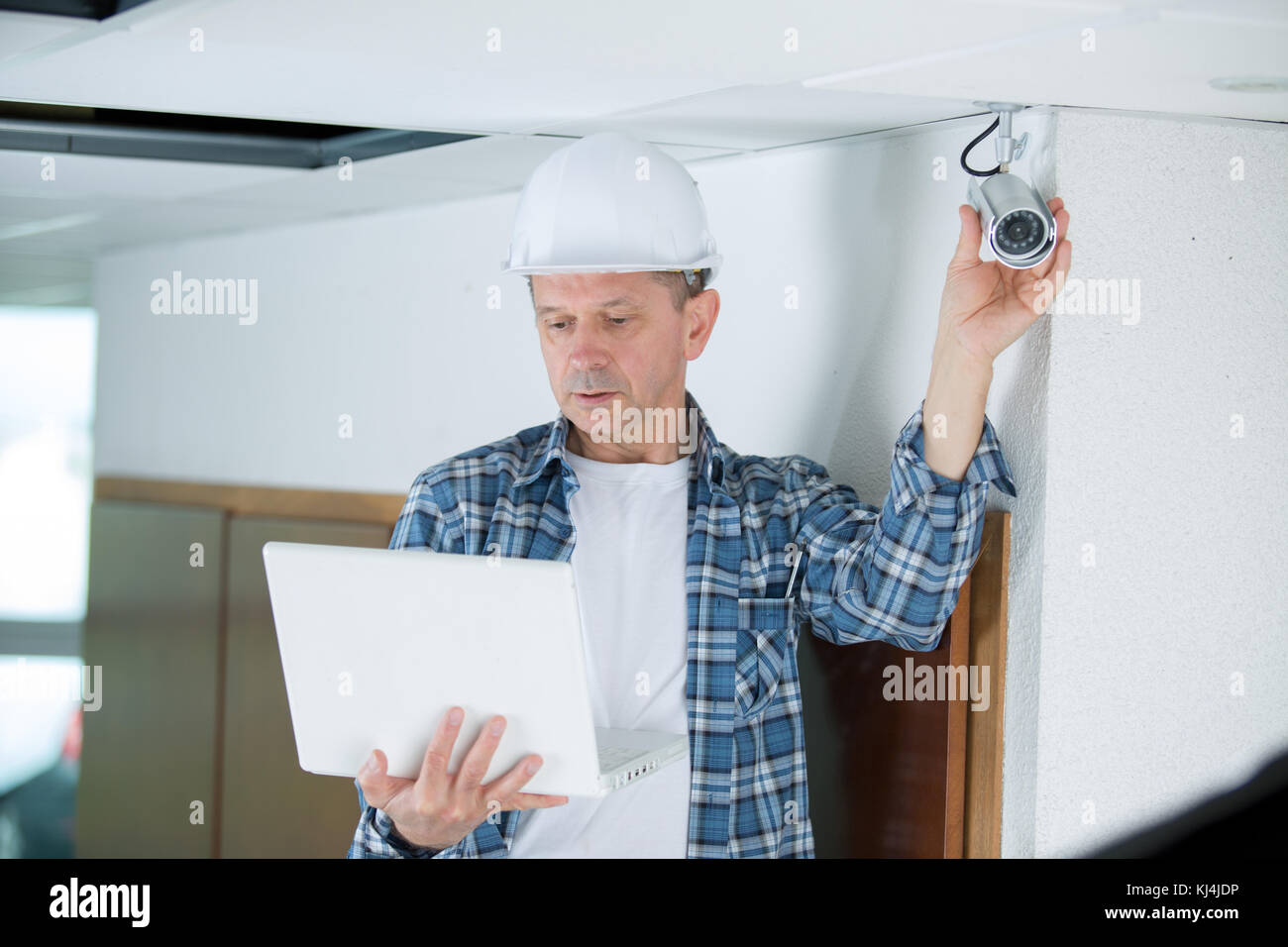 professional cctv technician checking instruction Stock Photo - Alamy