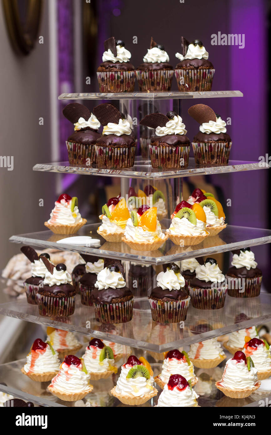 Sweet bridal buffet with cakes and muffins stacked in a pyramid ...