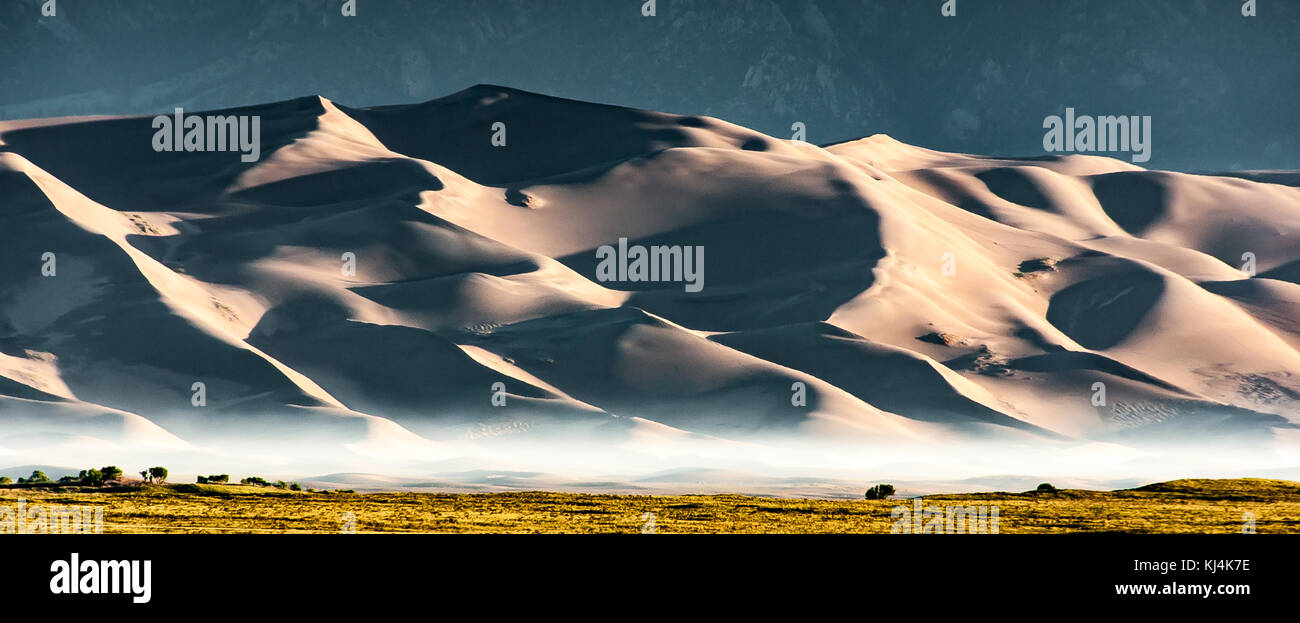 Early morning mist at the foot of the dunes in the desert of the Great ...