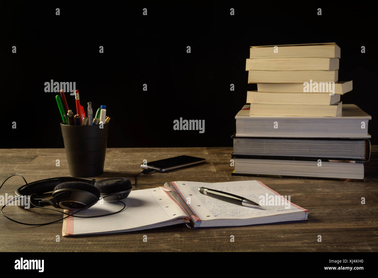 study table desk with books a open sketch book and pencil bucket ...
