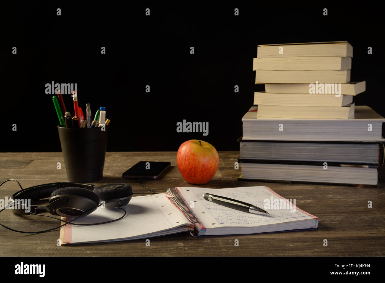 study table desk with books a open sketch book and pencil bucket ...