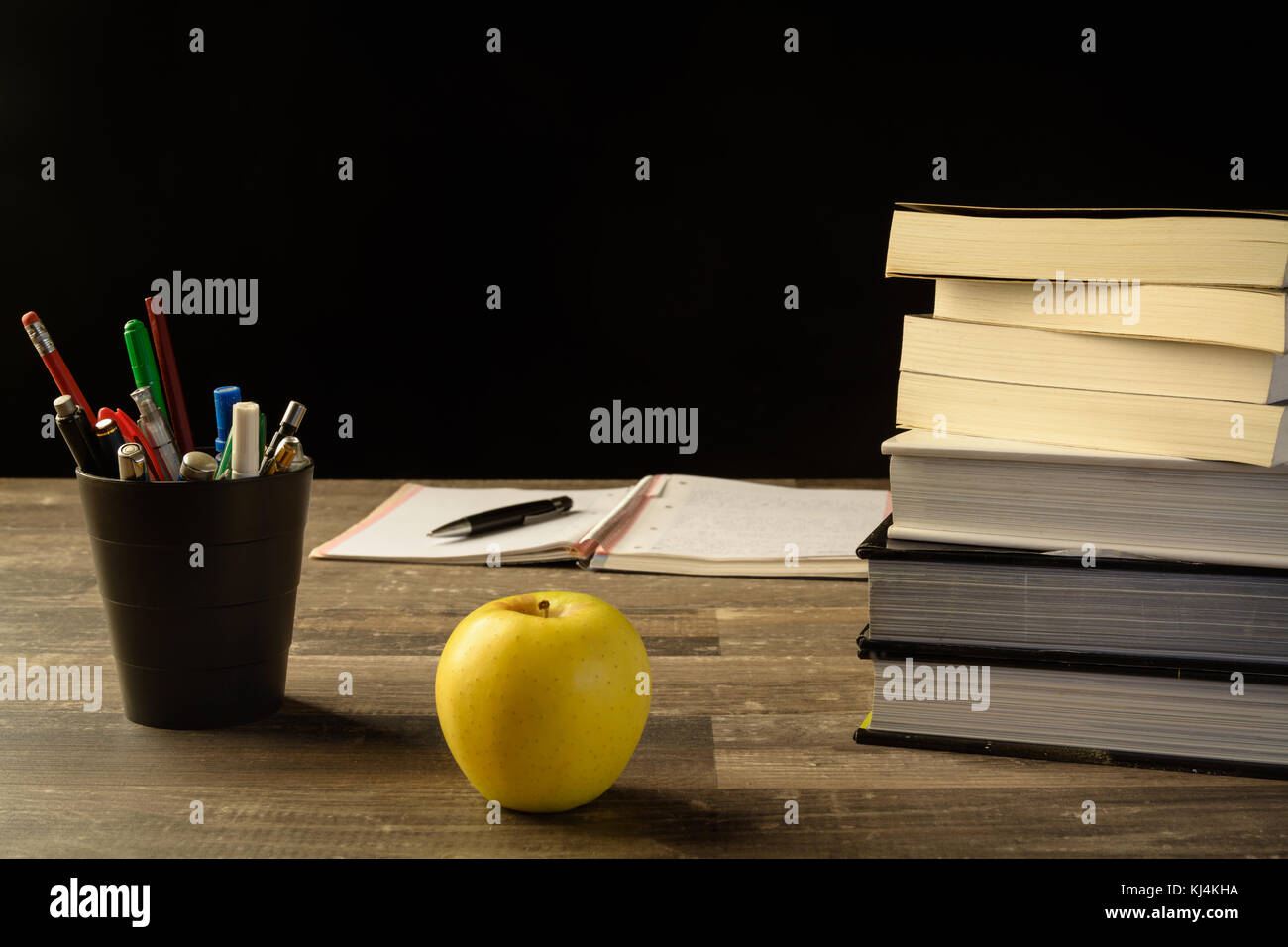 study table desk with books a open sketch book and pencil bucket ...