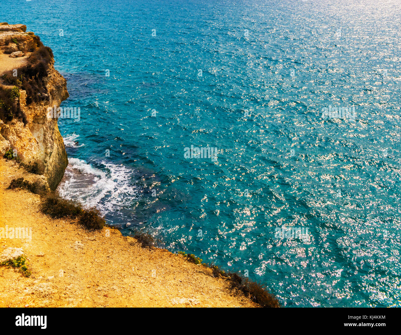 high cliff above the sea, summer sea background, many splashing waves ...