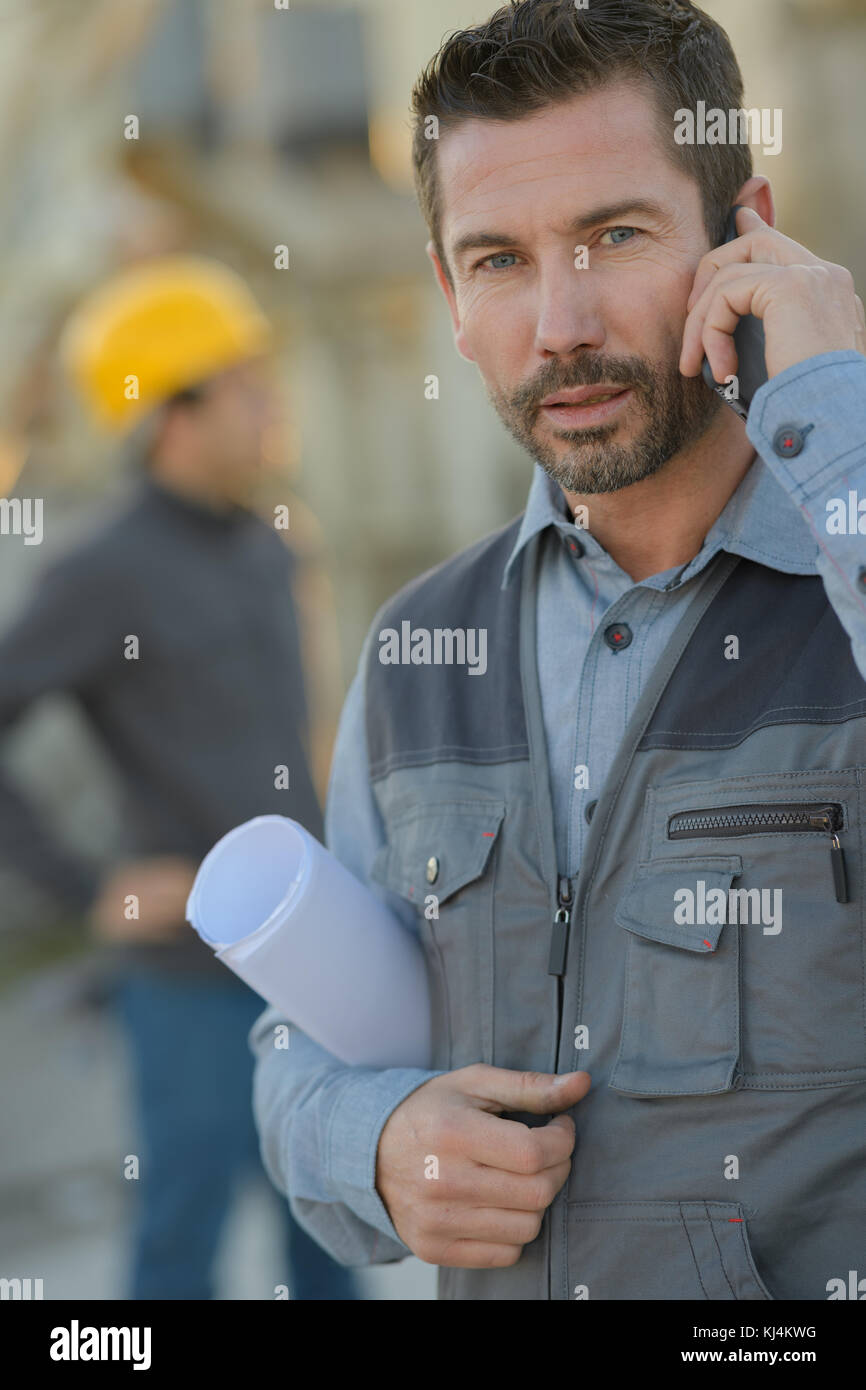 engineer holding the blueprint roll Stock Photo - Alamy