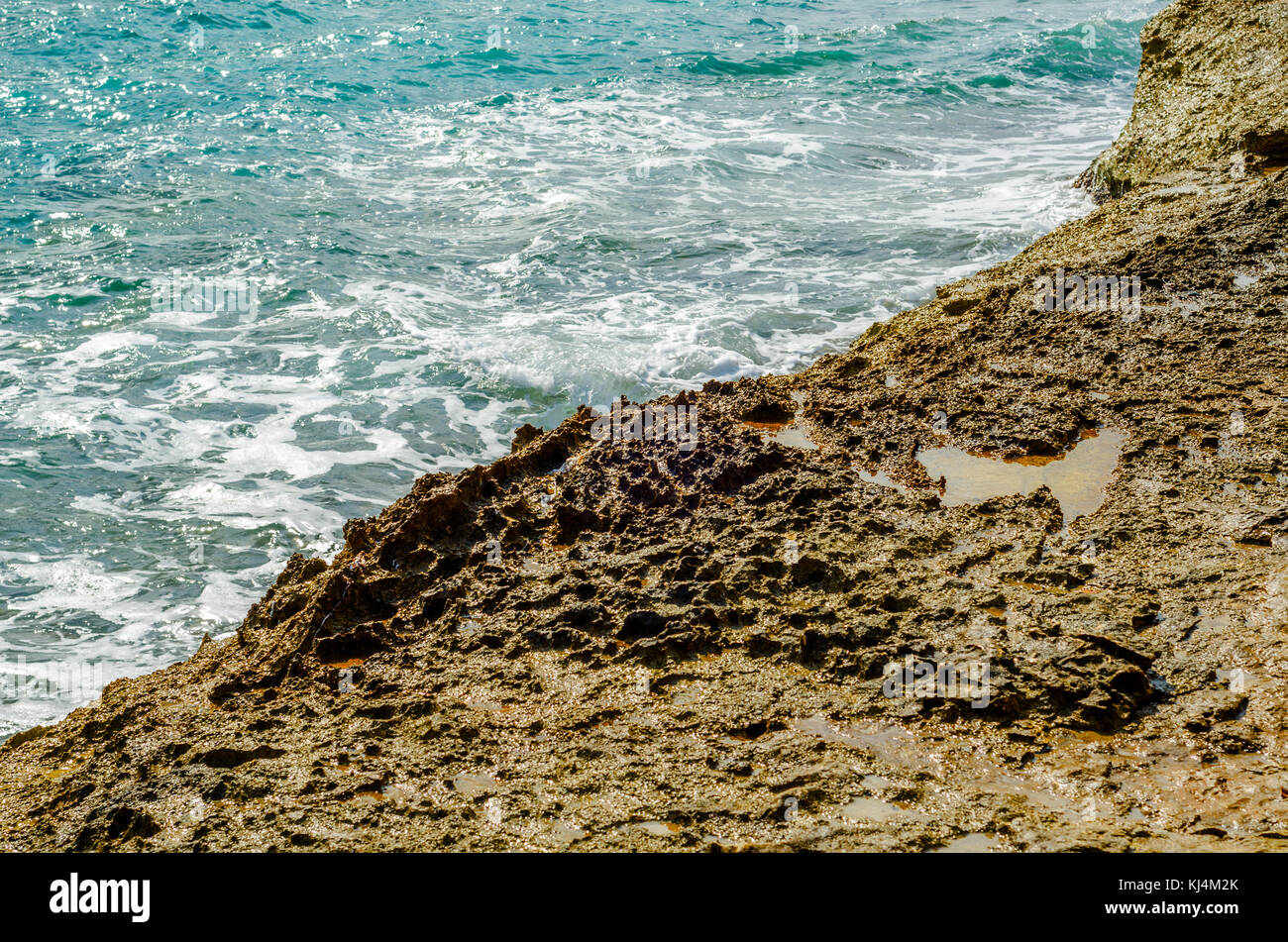 high cliff above the sea, summer sea background, many splashing waves ...
