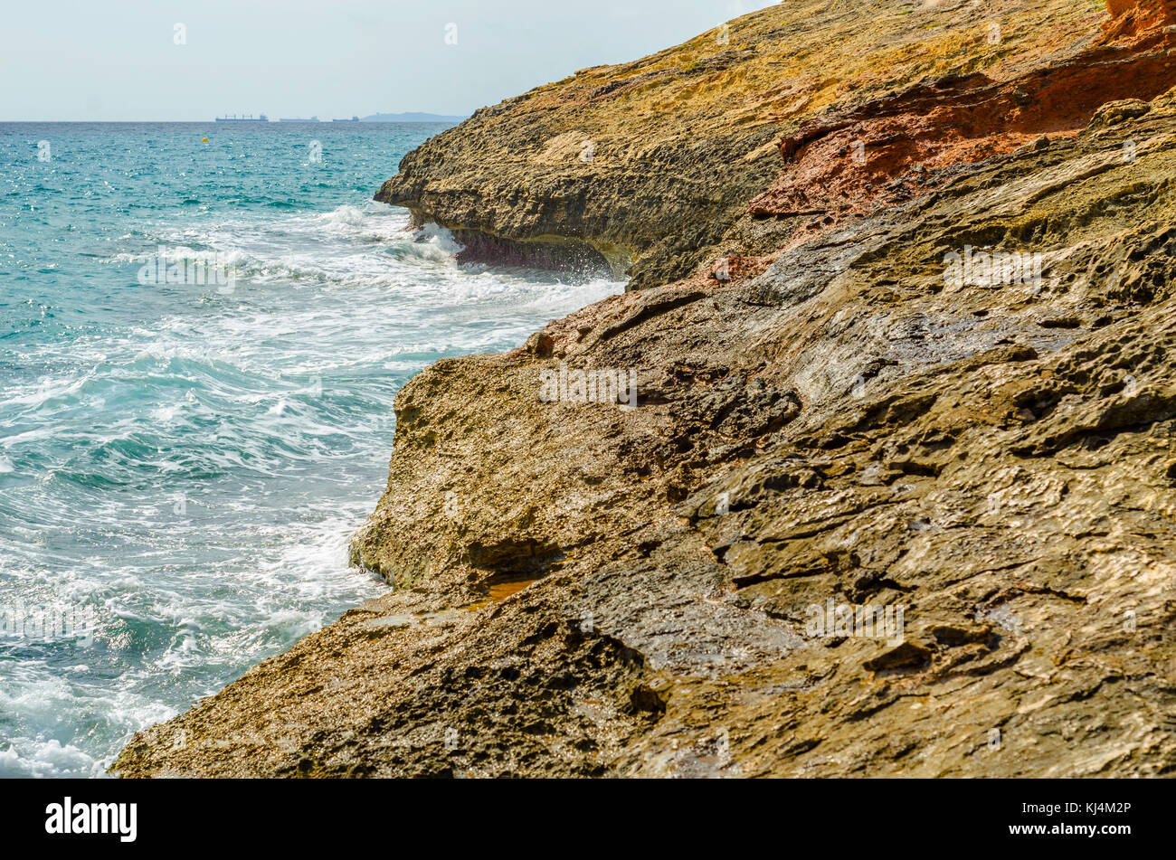 high cliff above the sea, summer sea background, many splashing waves ...