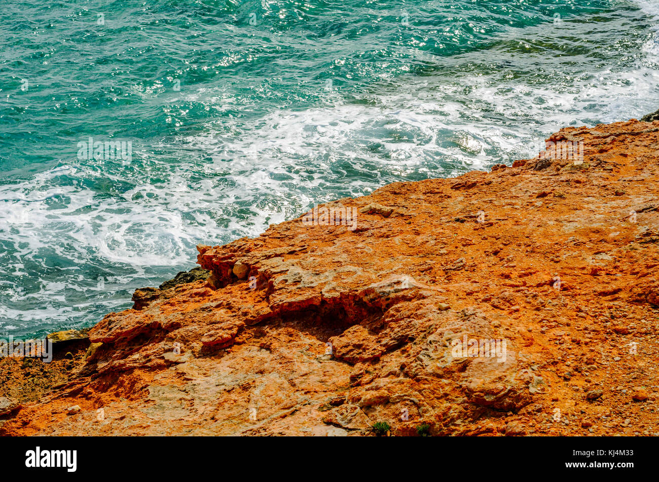 high cliff above the sea, summer sea background, many splashing waves ...