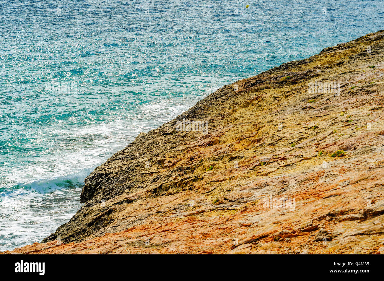 high cliff above the sea, summer sea background, many splashing waves ...