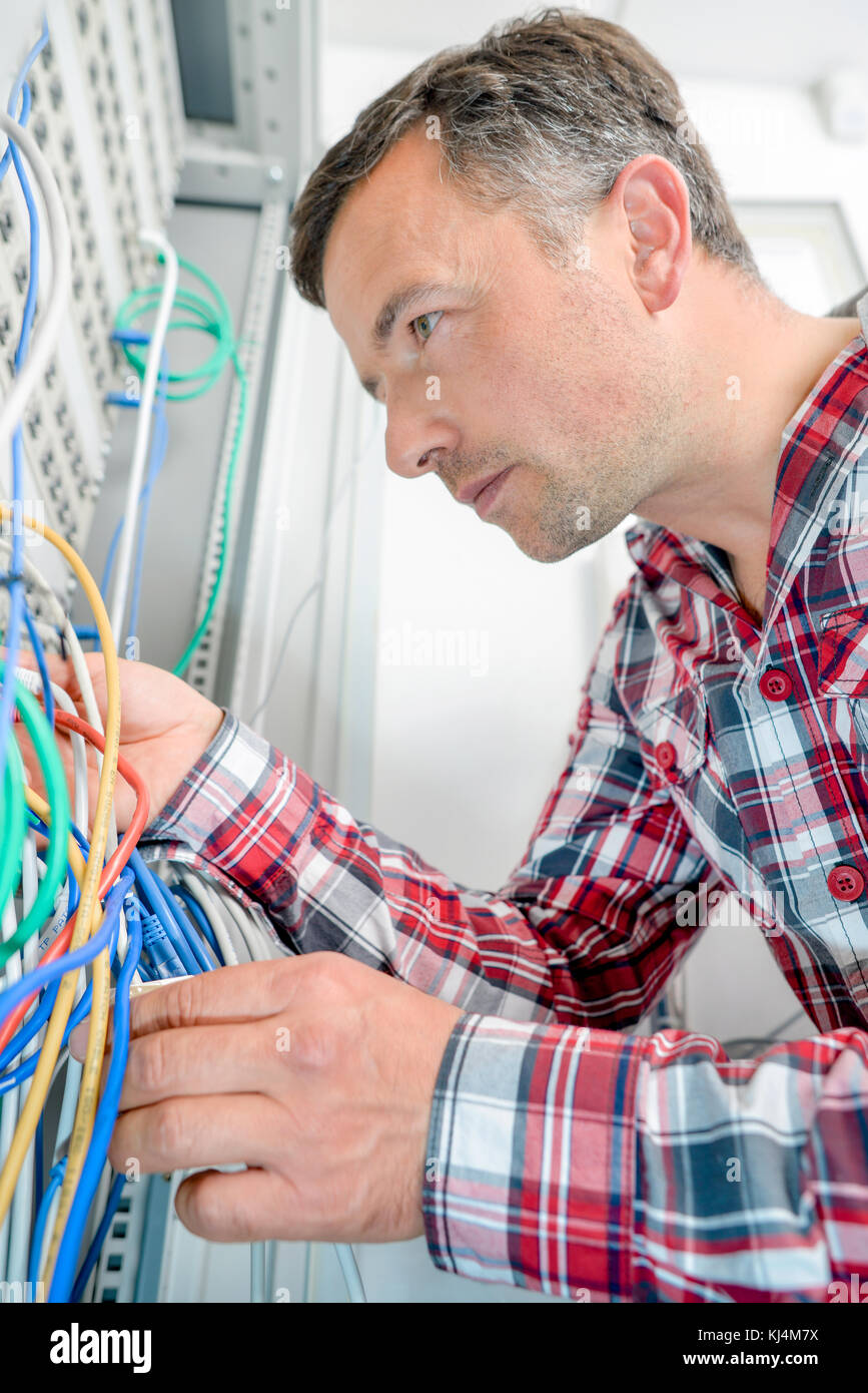 Man checking an electrical panel Stock Photo - Alamy