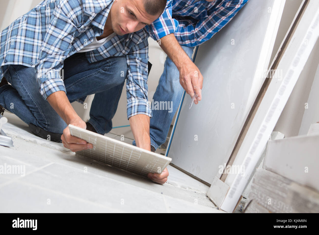 setting a tile Stock Photo - Alamy