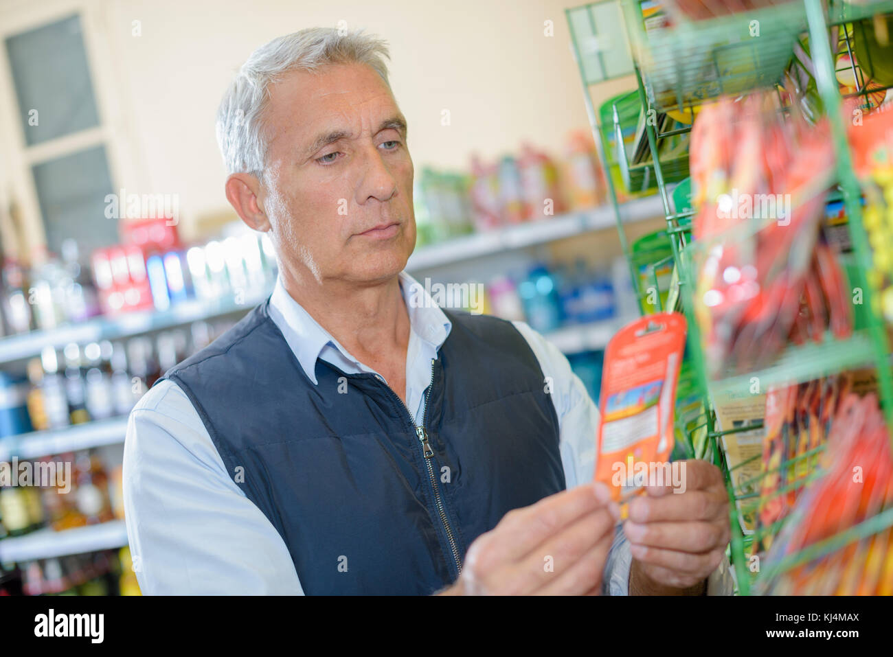 man reading a product's label Stock Photo - Alamy