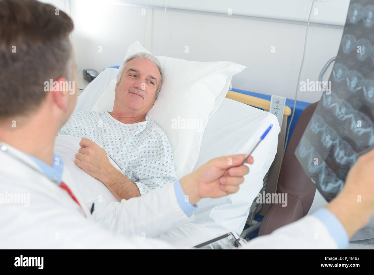 doctor examining patients xray in hospital room Stock Photo - Alamy