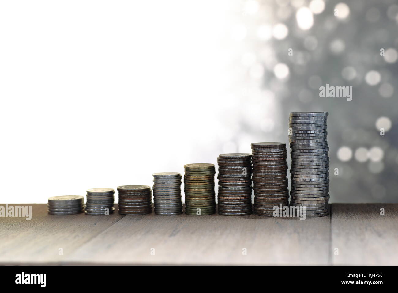 Coin stack with blur light dreamy bokeh background. Business, finance and saving concept Stock ...