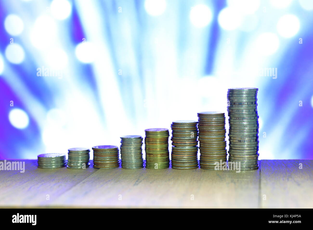 Coin stack with blur light dreamy bokeh background. Business, finance and saving concept Stock ...