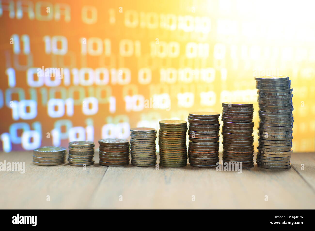 Digital economy. Coin stack increasing chart shape with orange light ...