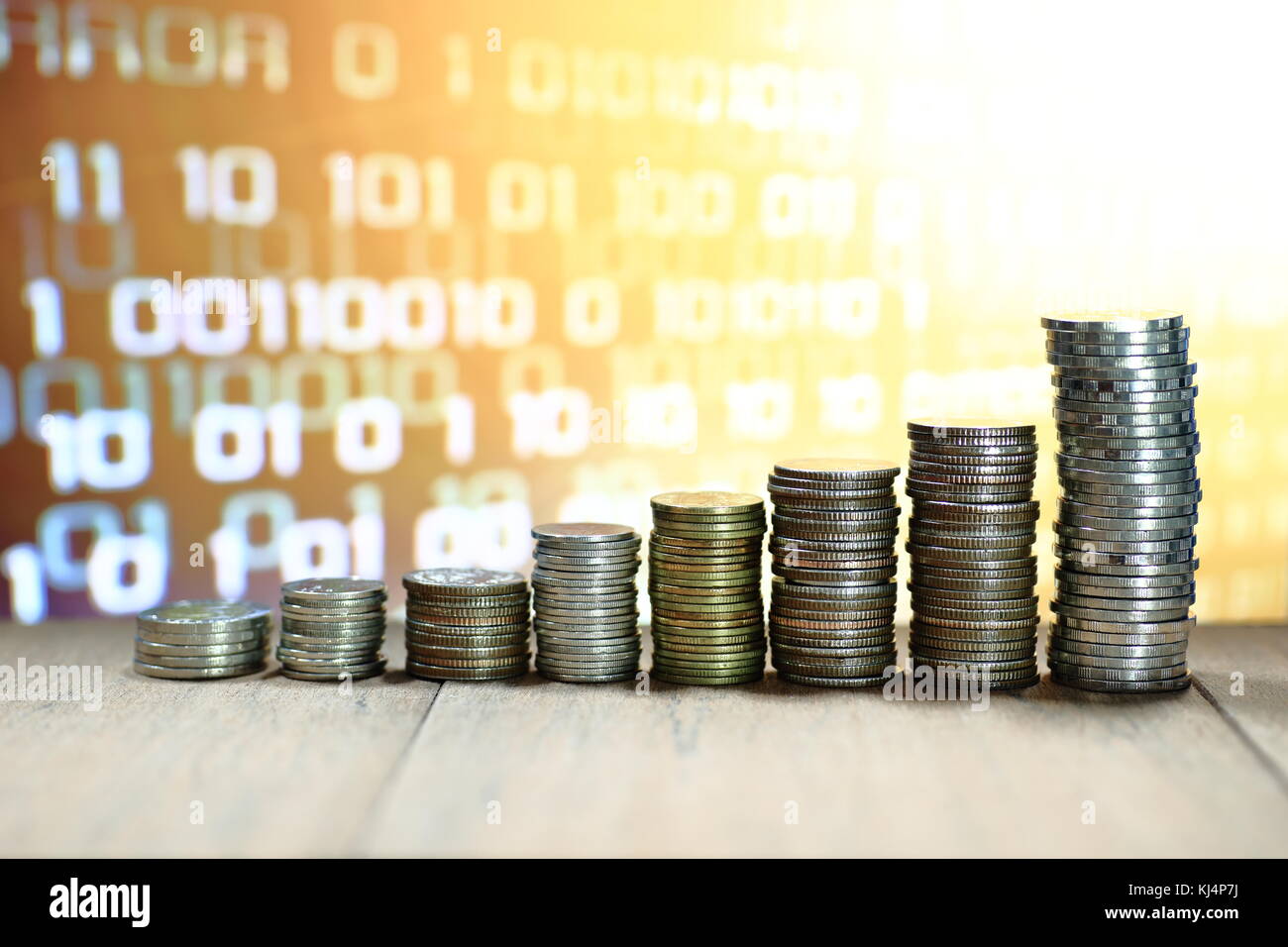 Digital economy. Coin stack increasing chart shape with orange light ...