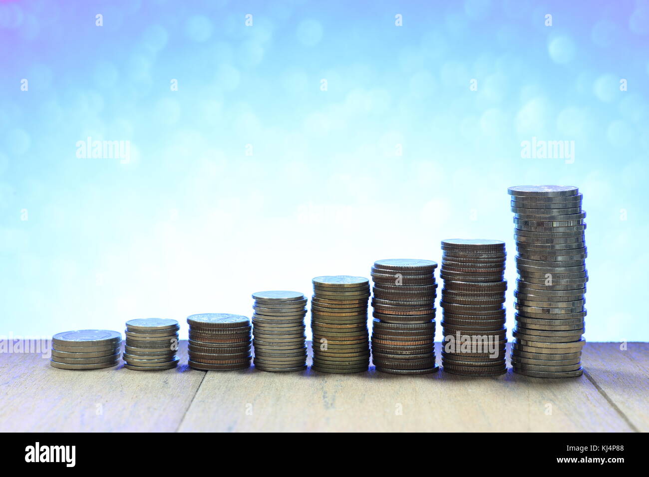 Coin stack with blur light dreamy bokeh background. Business, finance and saving concept Stock ...