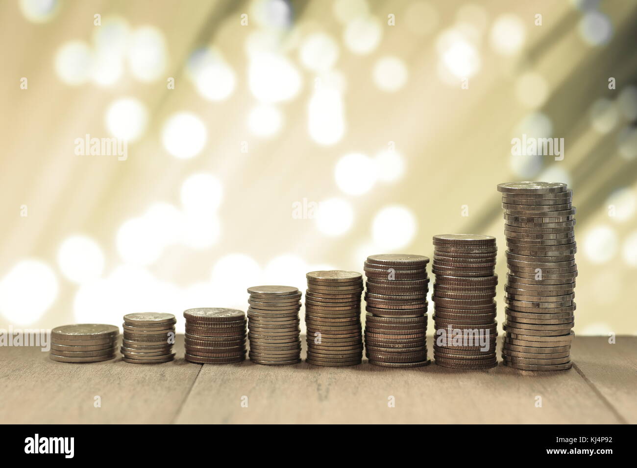 Coin stack with blur light dreamy bokeh background. Business, finance ...