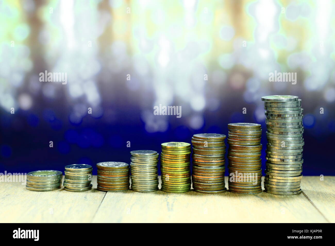 Coin stack with blur light dreamy bokeh background. Business, finance and saving concept Stock ...
