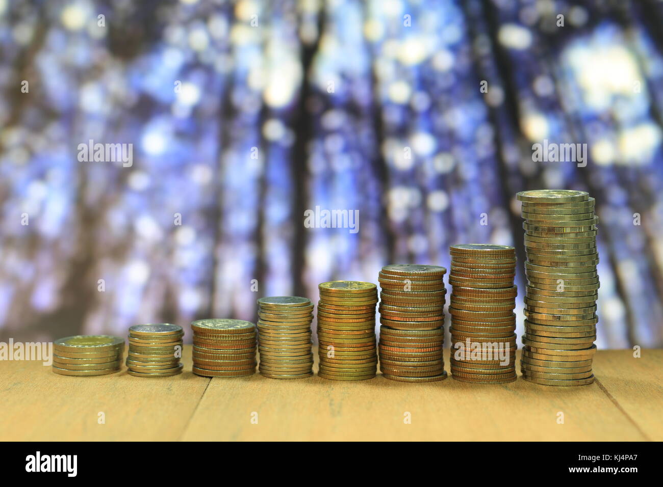 Coin stack with blur light dreamy bokeh background. Business, finance and saving concept Stock ...